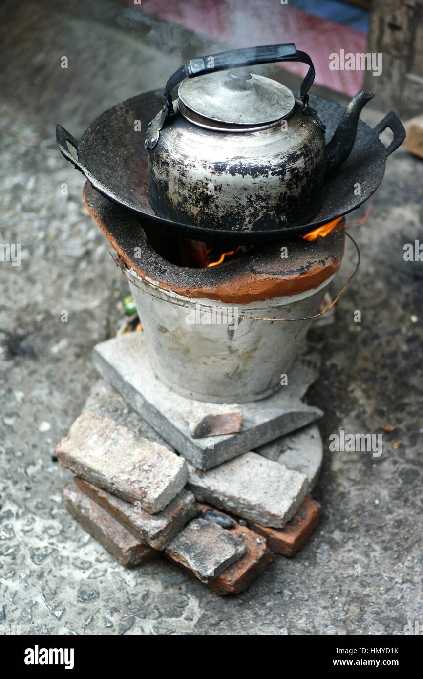 Boiling water using traditional fire Stock Photo - Alamy