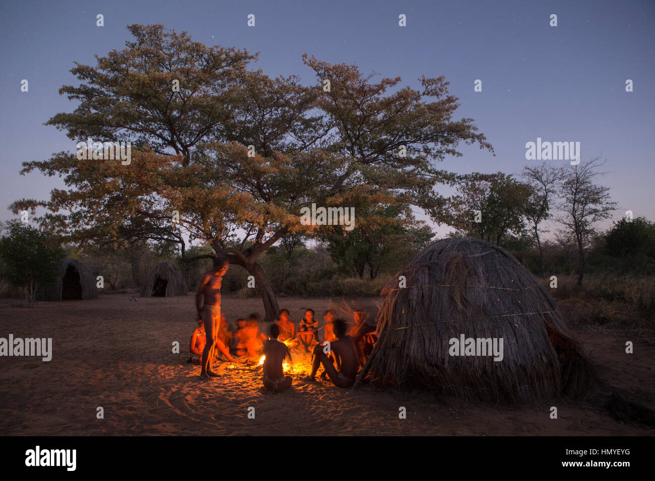 San Bushmen gather around a fire at dusk Stock Photo - Alamy
