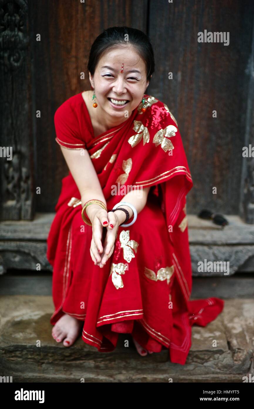 Chinese tourist wearing a traditional colorful shari dress from Tibet ...