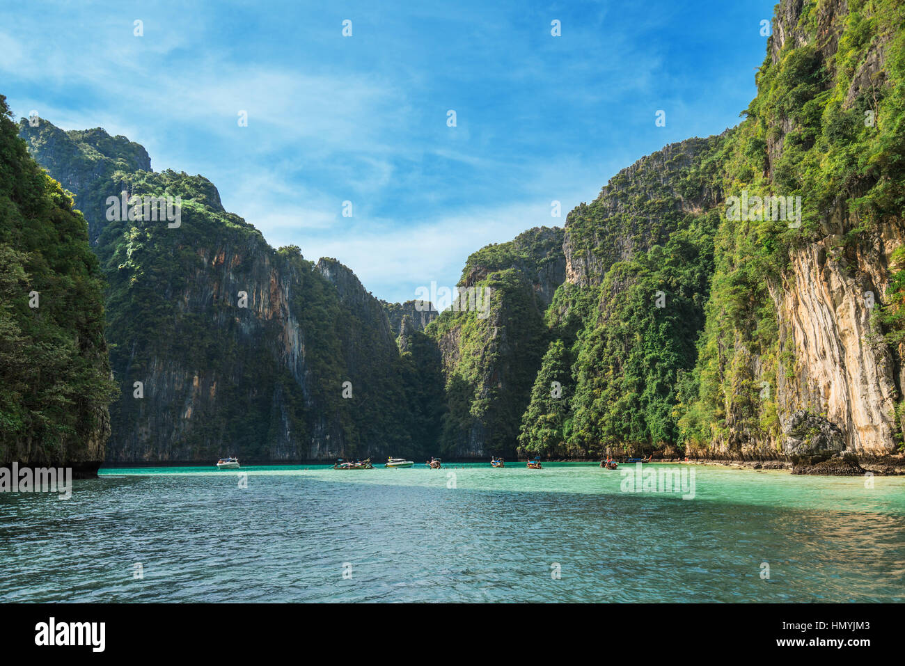 Jungle limestone cliffs around Phi-Phi Leh island with tourist boat ...