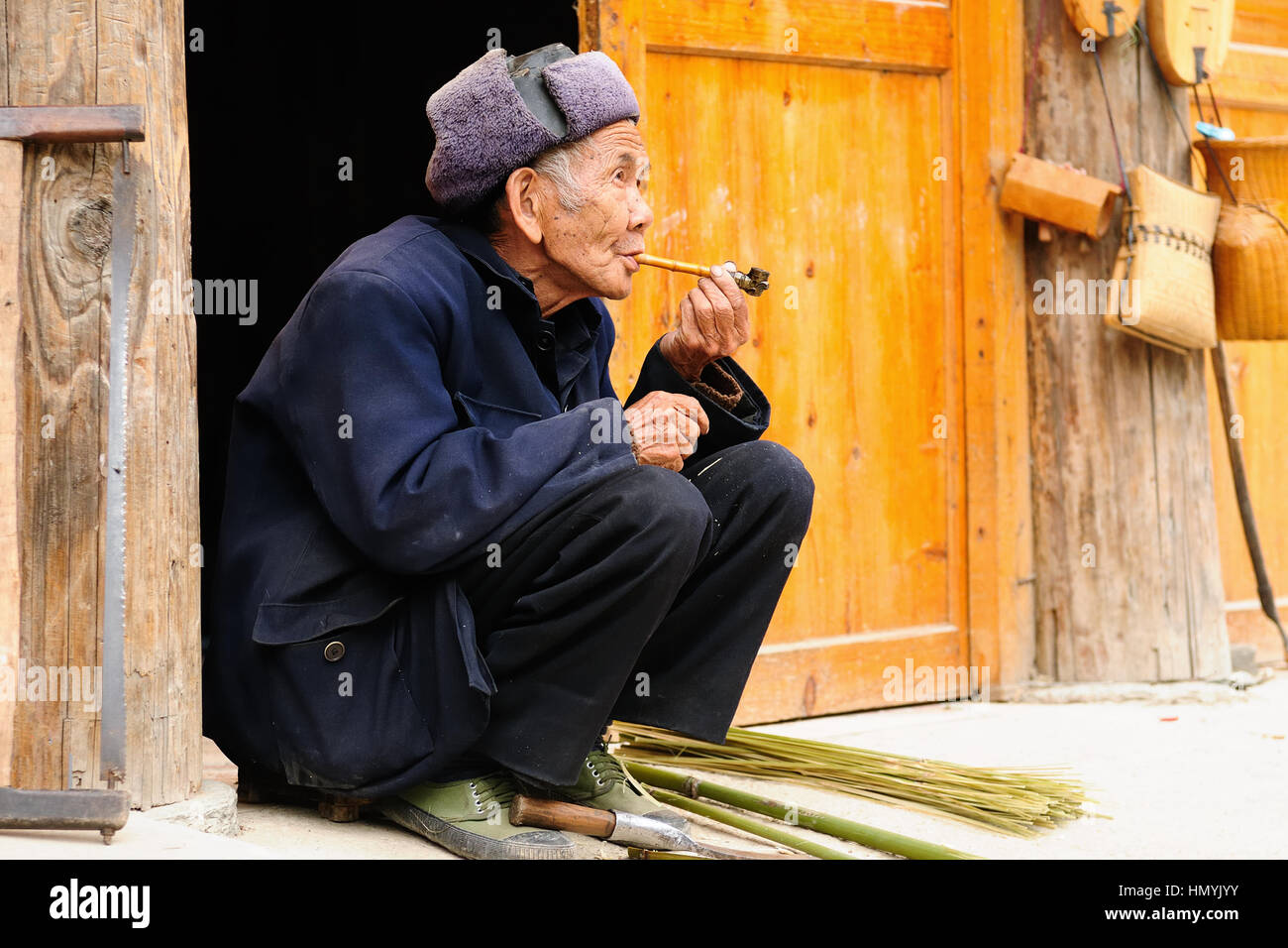 ZHAOXING, CHINA - NOVEMBER 11: Old Chinese resting on the doorstep of ...