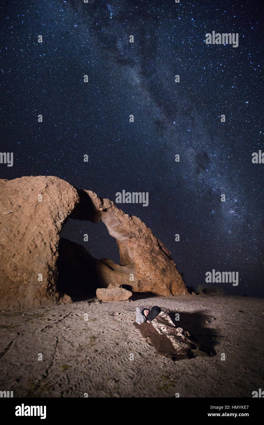 Camping under a rock arch Stock Photo - Alamy