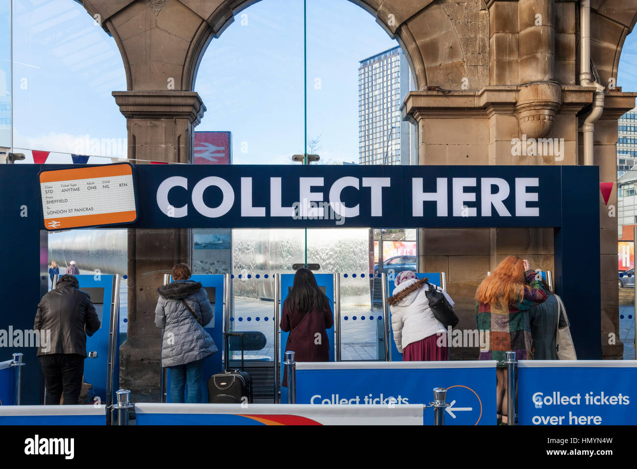 Passengers collecting train tickets at the ticket collection point ...