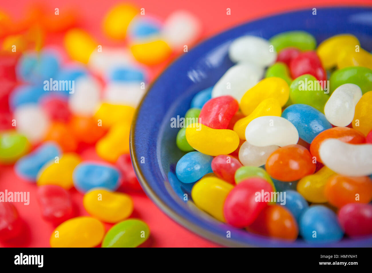 Colorful candy sweets on red background Stock Photo - Alamy