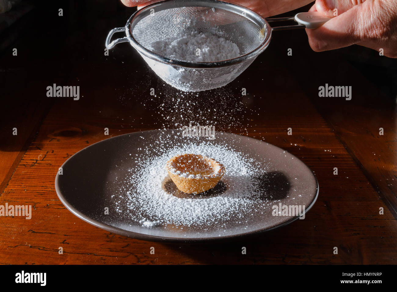 sprinkle with powdered sugar freshly baked cookies Stock Photo - Alamy