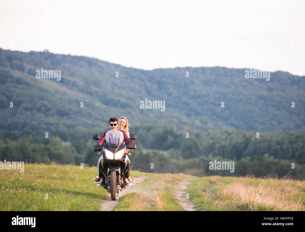 Couple in love enjoying a motorbike ride in countryside Stock Photo - Alamy