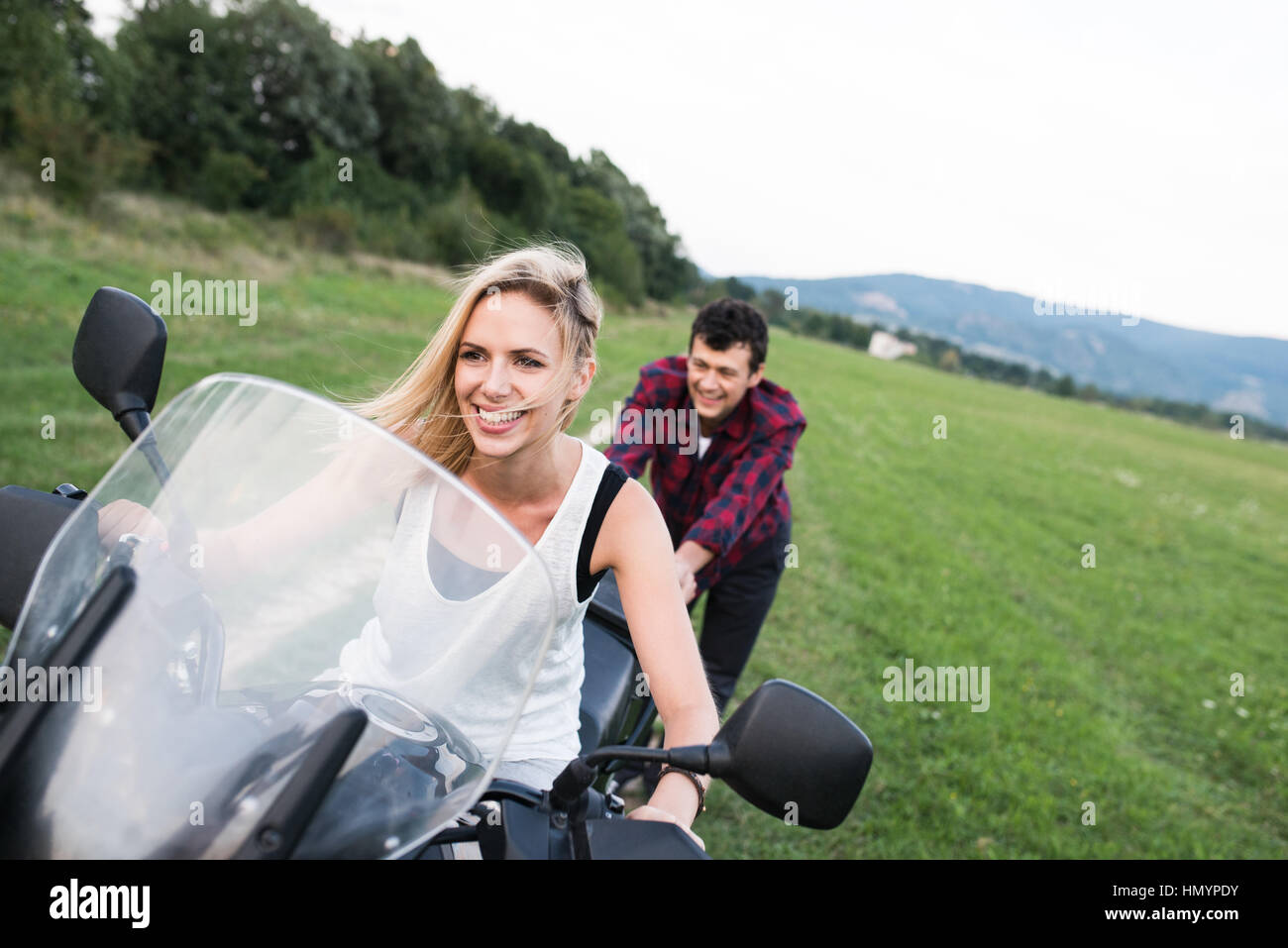 Couple in love enjoying a motorbike ride in countryside Stock Photo - Alamy