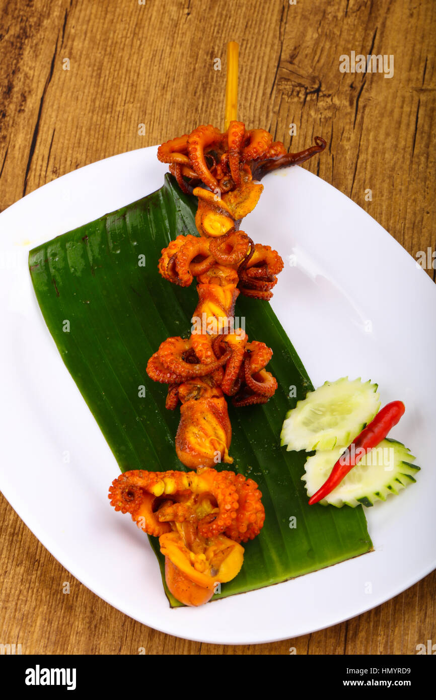 Asian octopus skewer on banana leave with pepper Stock Photo - Alamy
