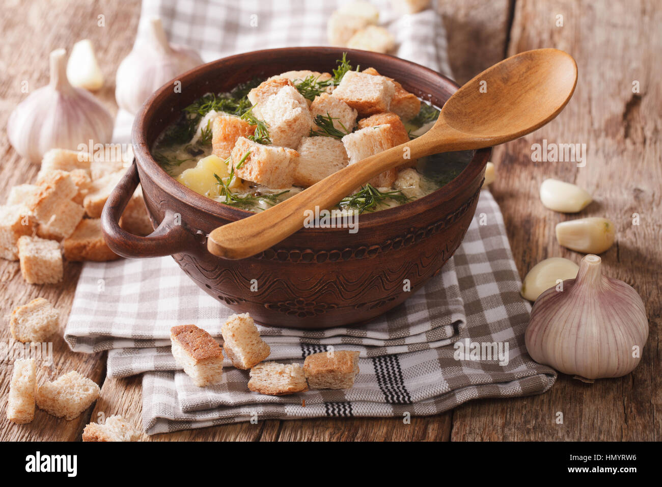 Homemade garlic soup with croutons close-up in a bowl on the table ...