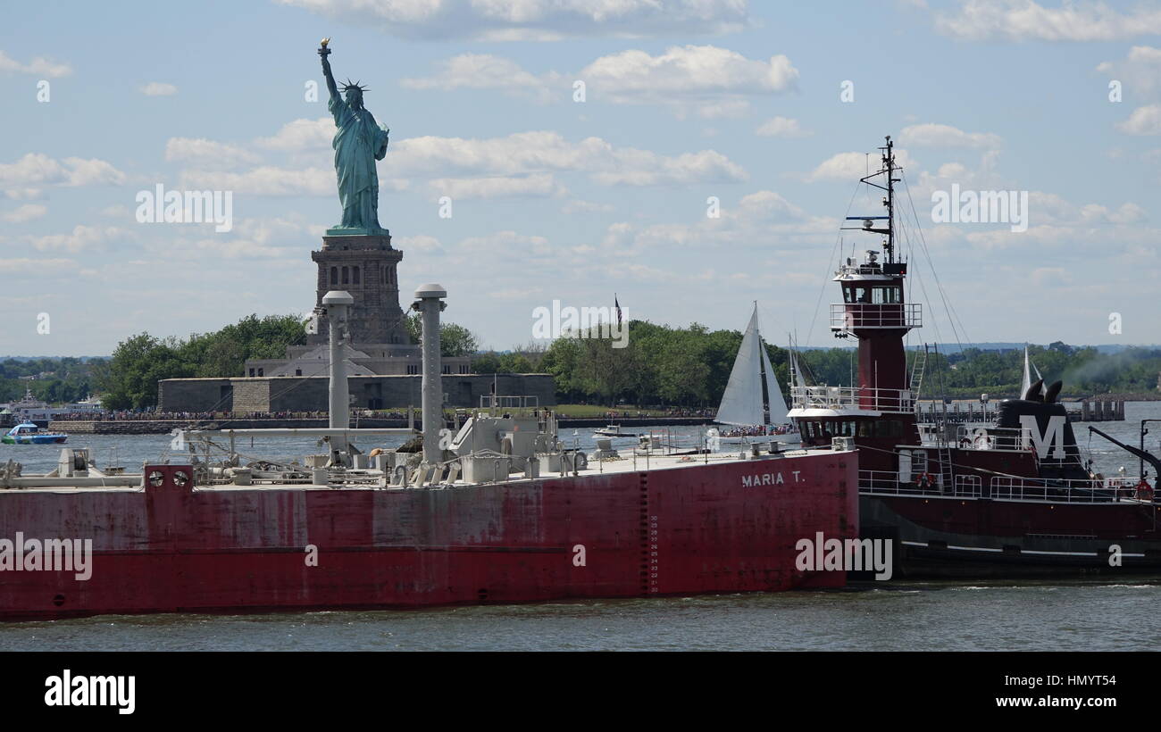 Tugboat Pushing Ship In Harbor Stock Photo - Alamy