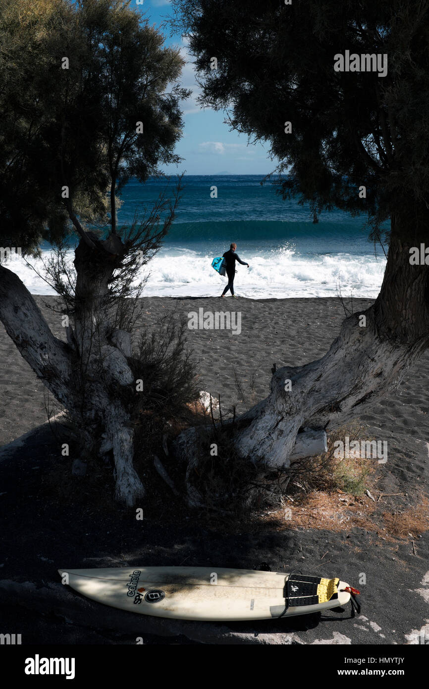 A surfer on Perissa beach, Santorini, Greece Stock Photo - Alamy