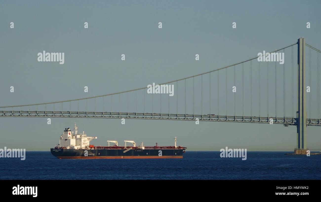 Ocean Cargo Ship And Suspension Bridge Stock Photo - Alamy