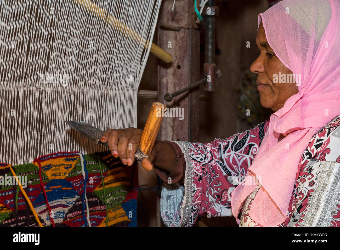 Morocco. Berber Woman Weaving a Rug in her Home. Ait Benhaddou Ksar, a ...