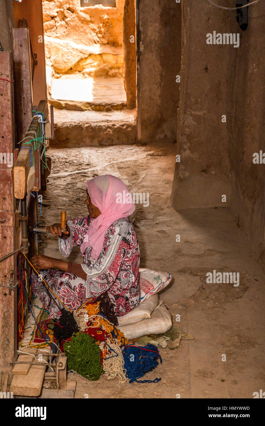 Berber woman weaving traditional rug hi-res stock photography and ...