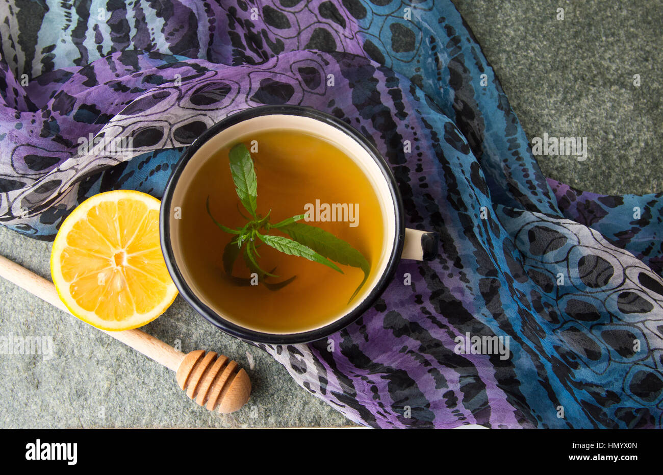 Cannabis herbal tea with lemon on stone table Stock Photo - Alamy