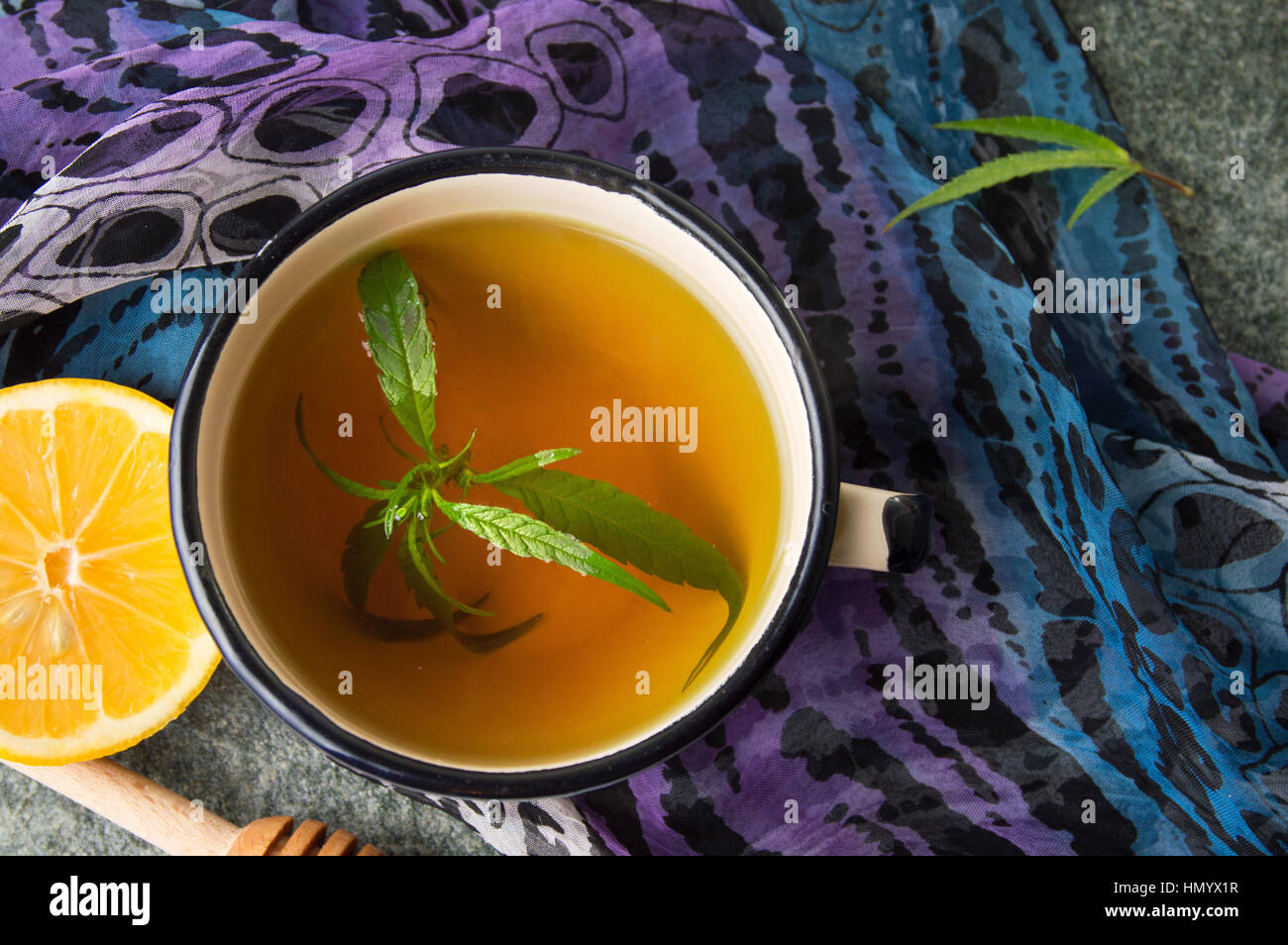 Cannabis herbal tea with lemon on purple fabric Stock Photo - Alamy