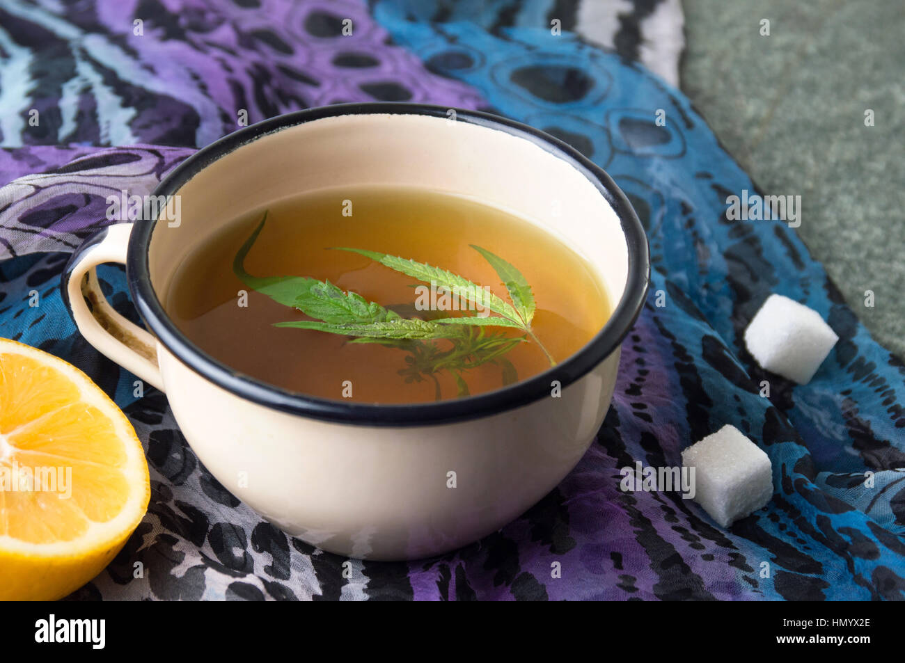 Cannabis herbal tea with lemon on stone table Stock Photo - Alamy