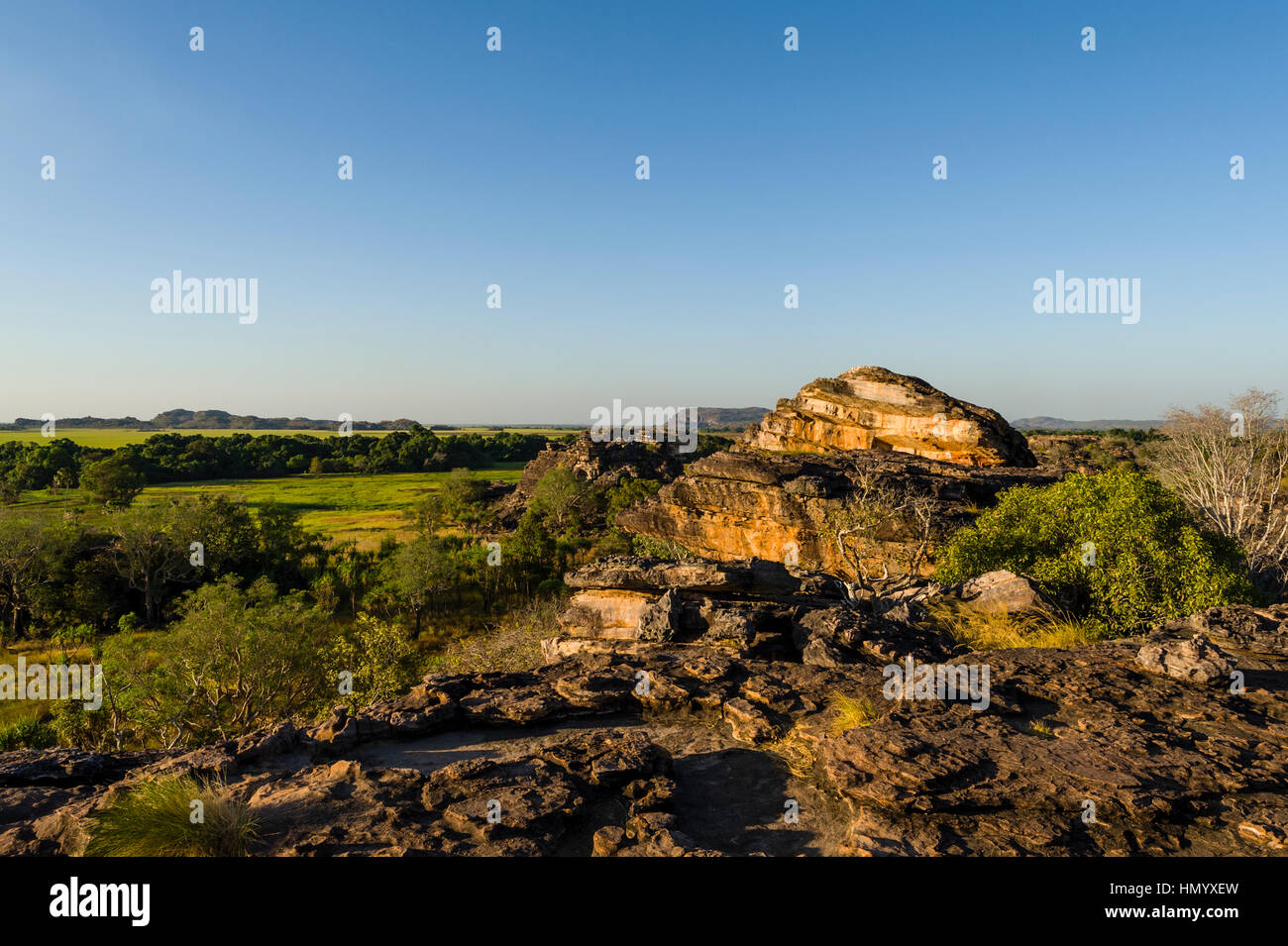 A rugged sandstone escarpment overlooking a floodplain at sunset Stock ...