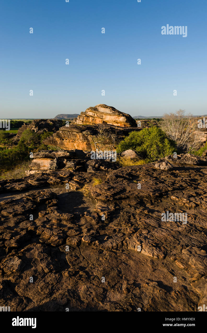 A rugged sandstone escarpment overlooking a floodplain at sunset Stock ...