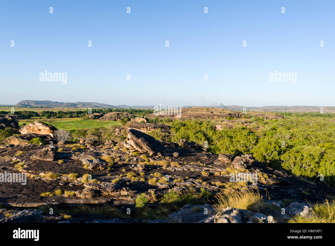 A rugged sandstone escarpment overlooking a floodplain at sunset Stock ...