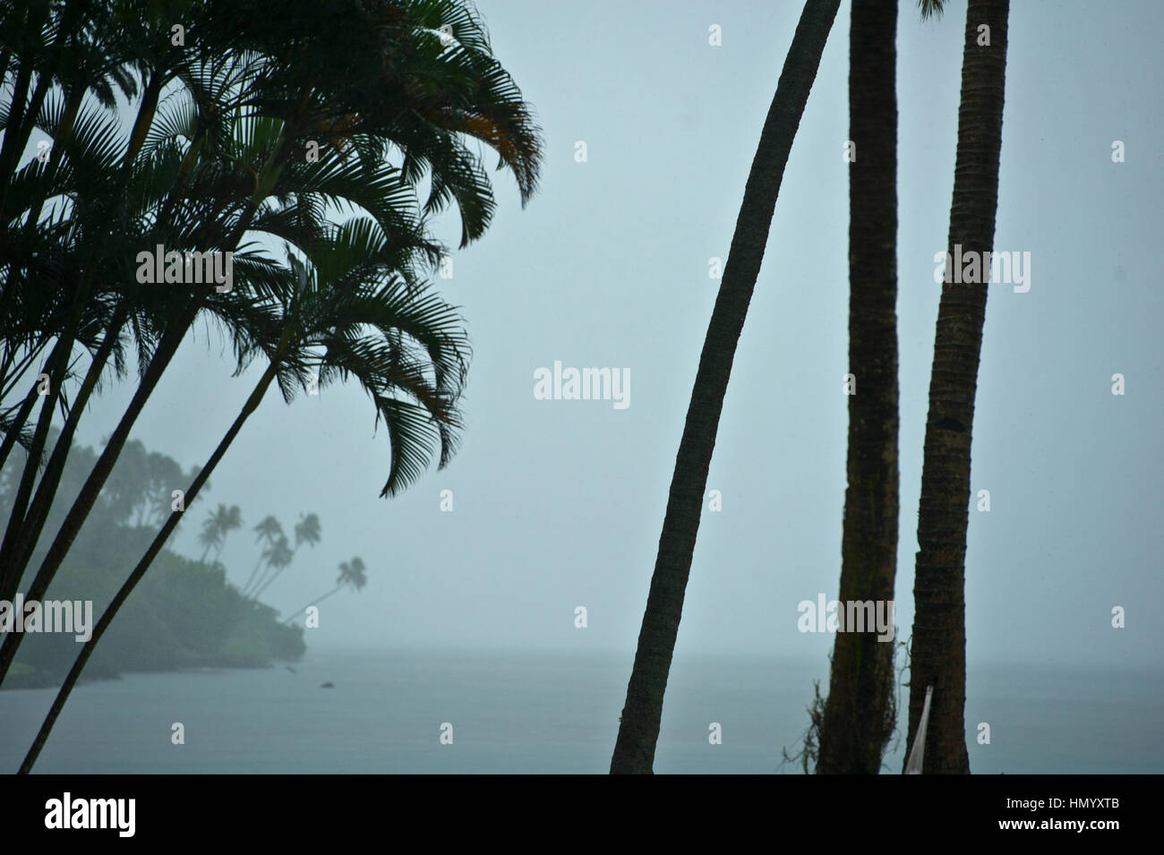A rainstorm descends over a tropical island Stock Photo - Alamy