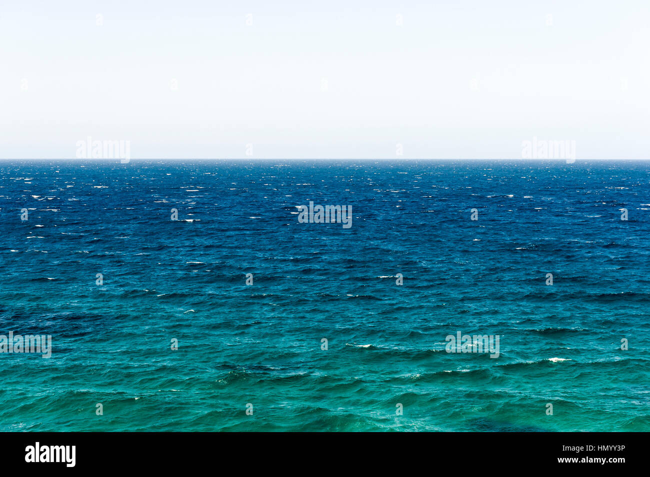 The wind-blown surface and horizon of a turquoise ocean Stock Photo - Alamy