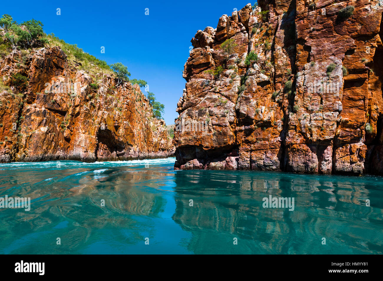 A fast moving tidal flow through a narrow gorge beneath the high tide ...