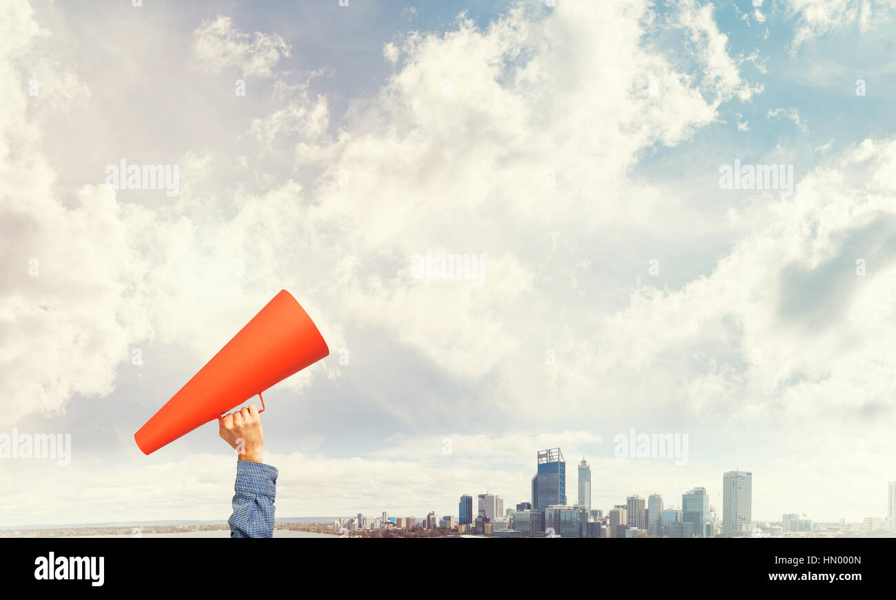 Close of man making announcement in paper trumpet Stock Photo - Alamy