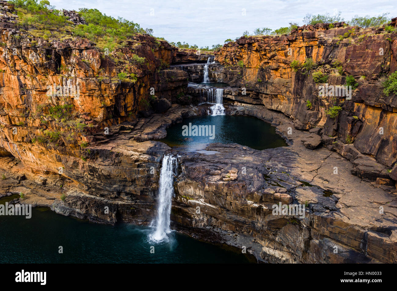 The magnificent Mitchell River cascades down ochre sandstone tiers in ...