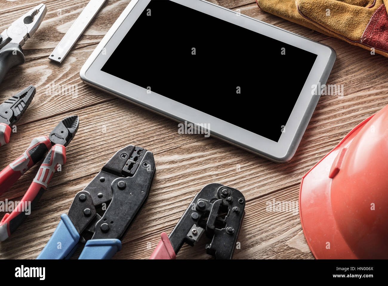 Variety of tools of builder and tablet pc on wooden texture table Stock ...