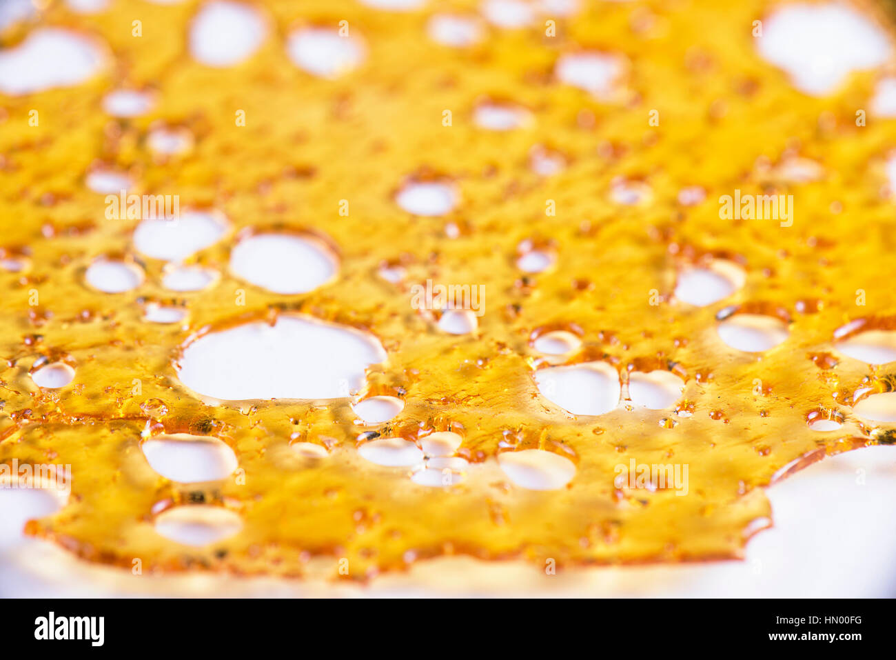 Macro detail of cannabis oil concentrate aka shatter forming a pattern ...