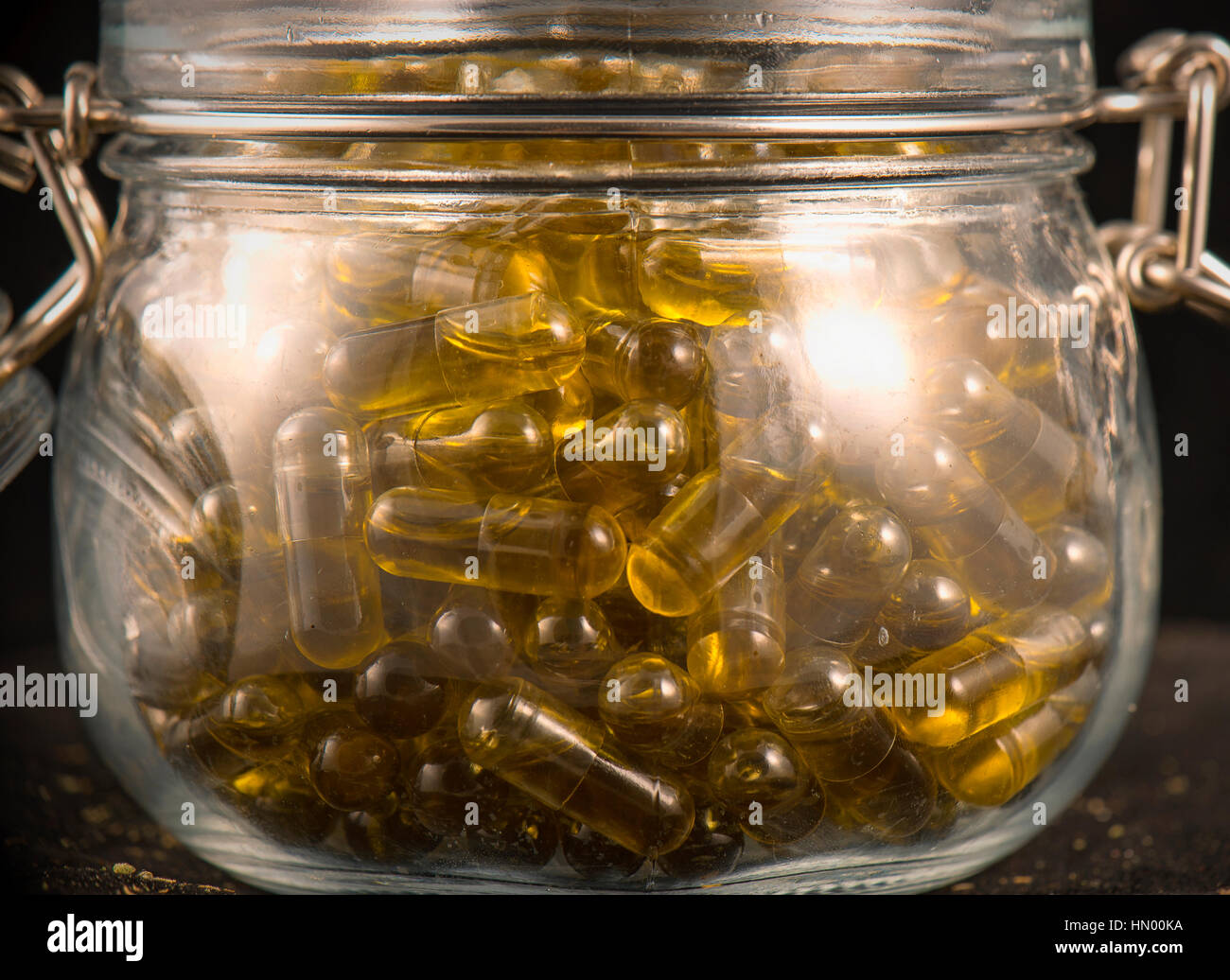 Jar filled with cannabis extraction capsules infused with shatter and ...