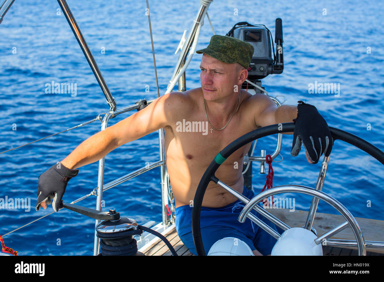 Young man skipper of a sailing yacht. Luxury vacation. Extreme sports ...