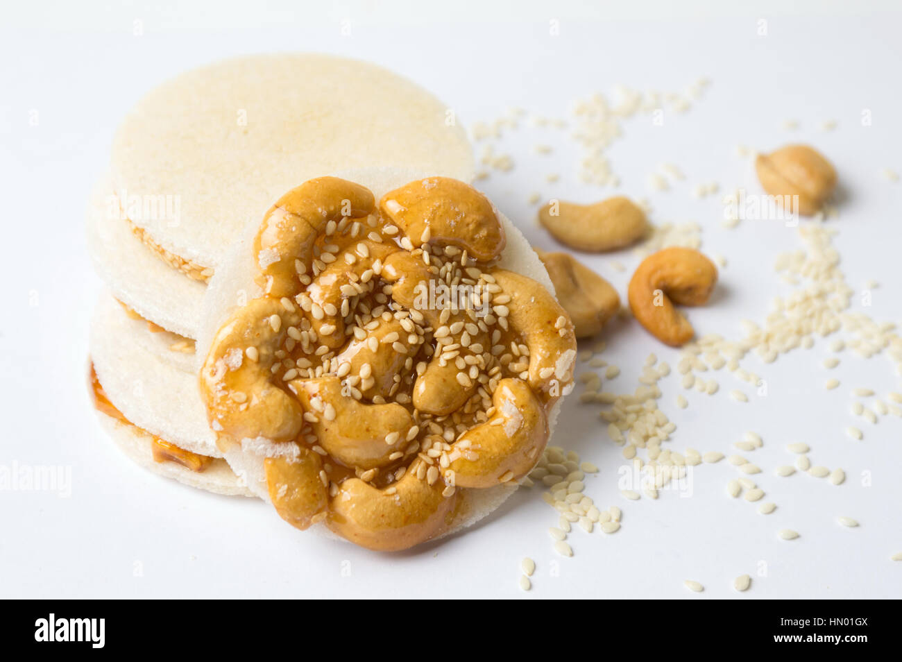 Cashew caramelised sweet snack with seeds on white Stock Photo - Alamy