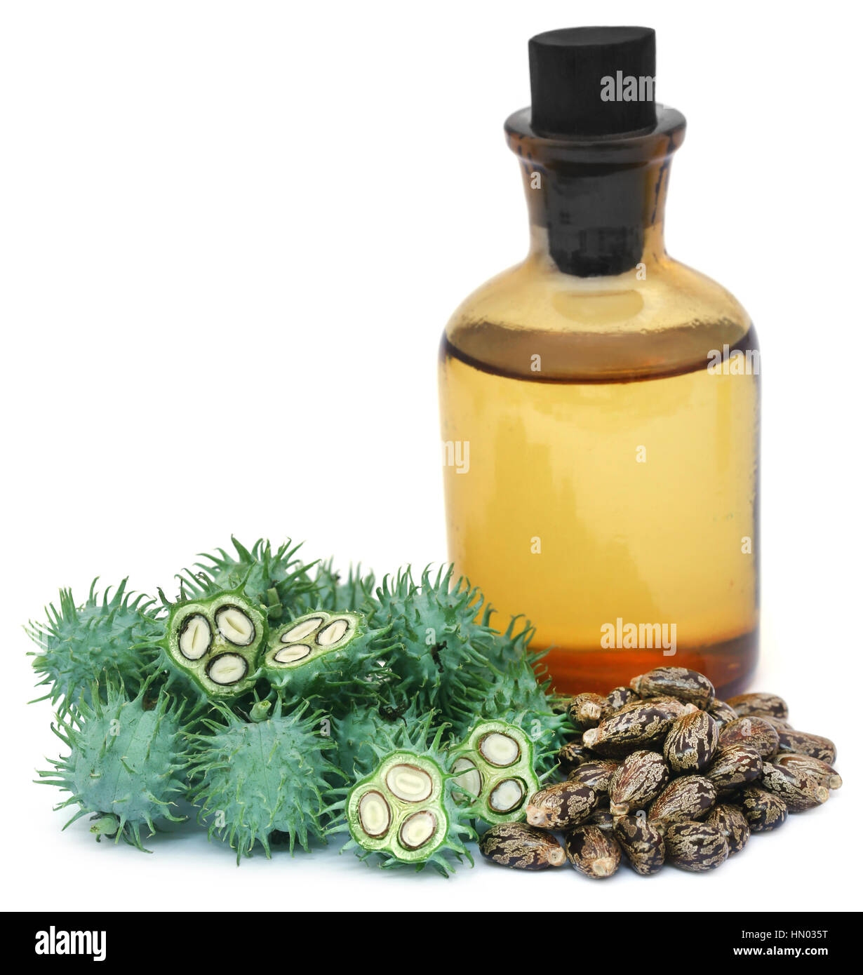 Green castor beans with essential oil Stock Photo - Alamy