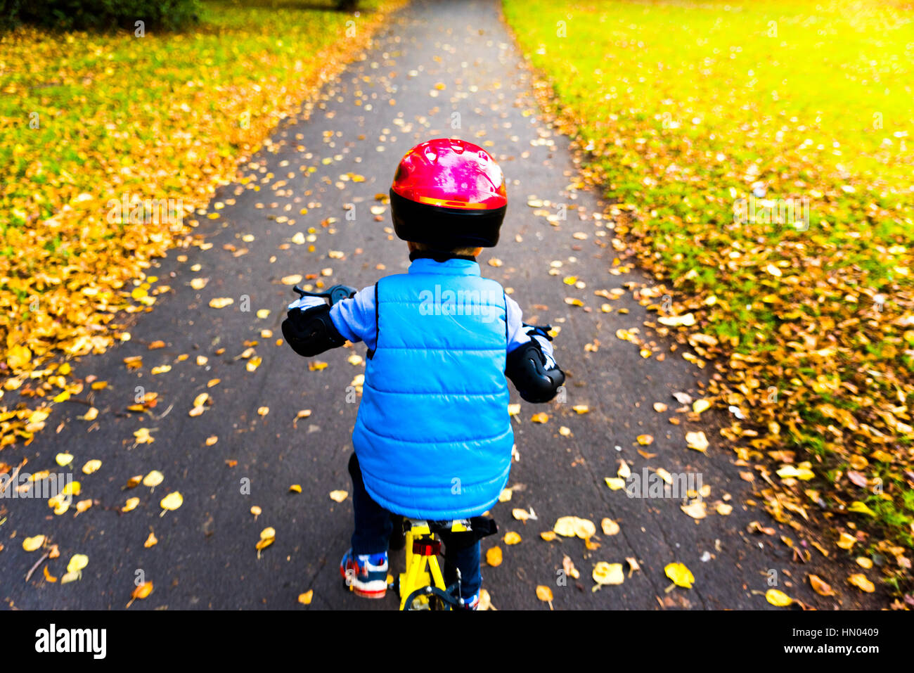 Overhead view of a boy riding bike with safety helmet outdoors at ...
