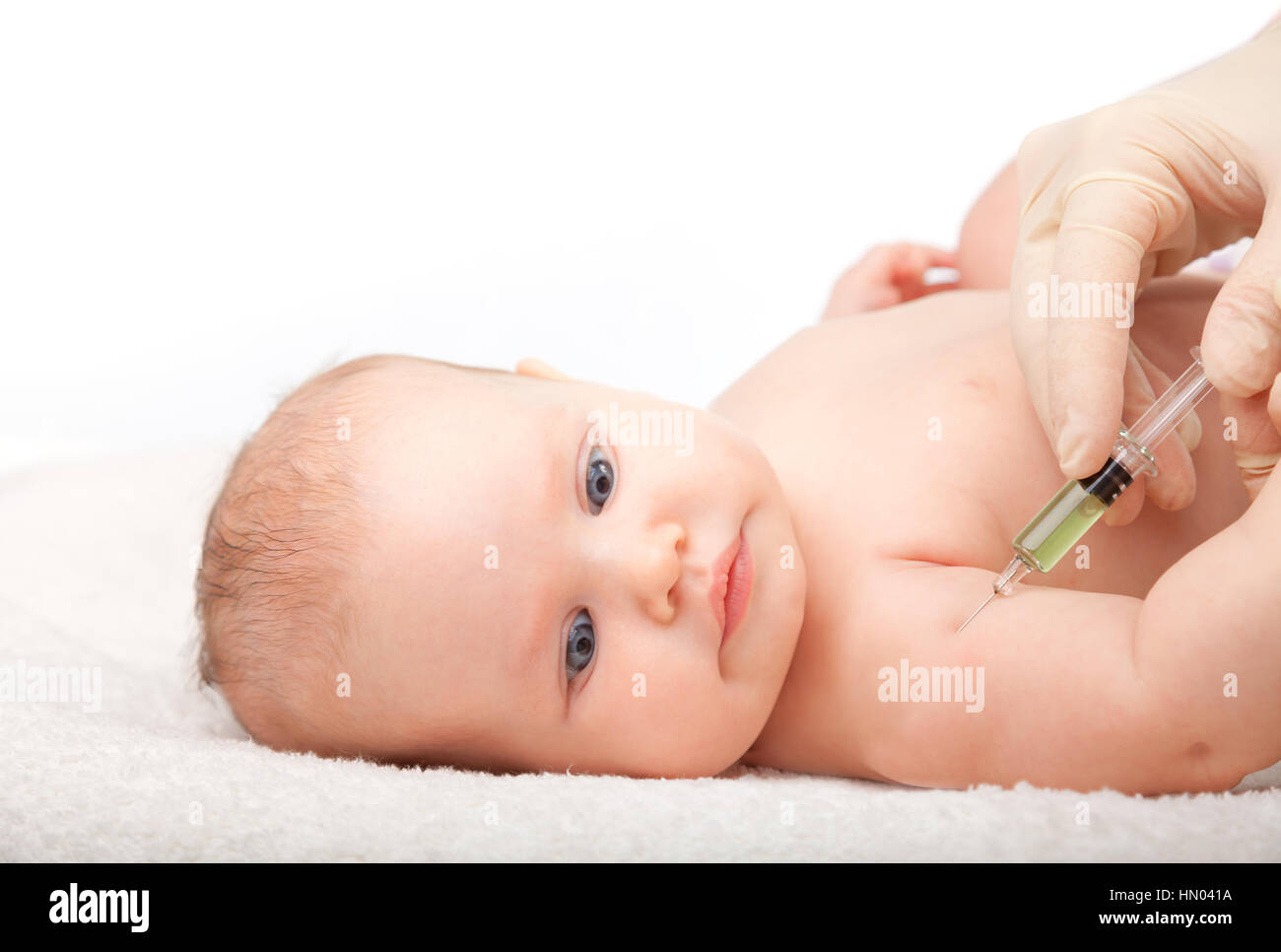 Close-up shot of pediatrician giving a three month baby girl ...