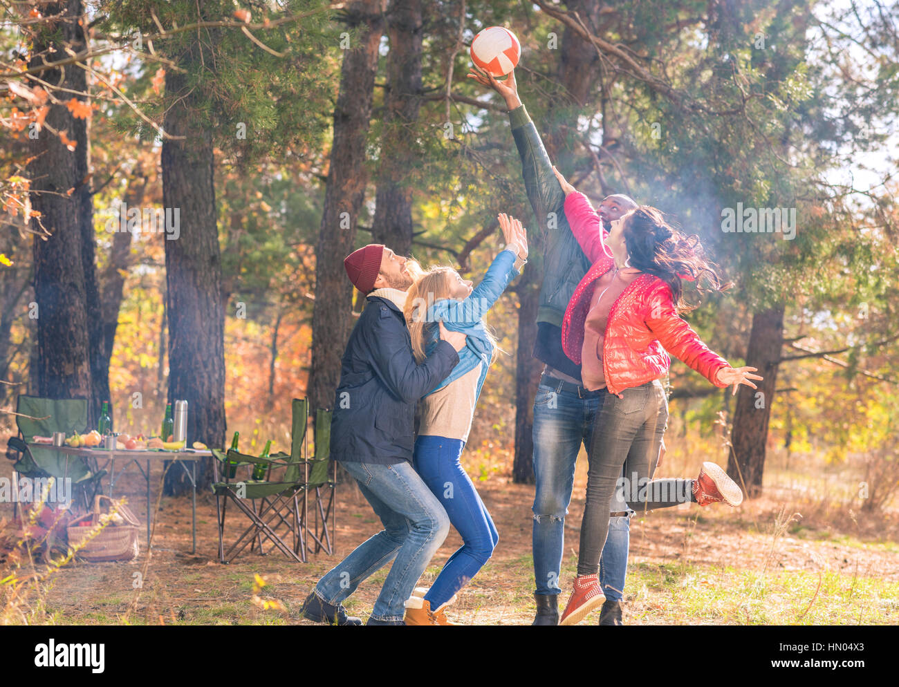 Happy friends playing with ball in park Stock Photo - Alamy