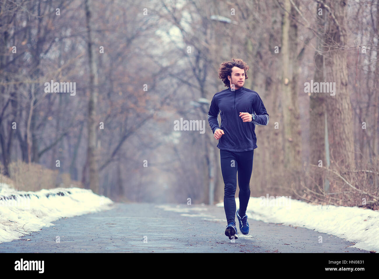 Young runner running in the park in spring, autumn on nature Stock ...