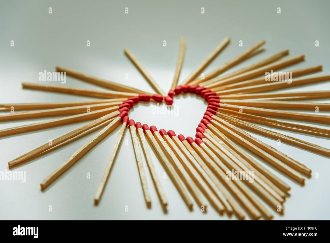 closeup of matchsticks arranged to form a heart shape with depth of ...