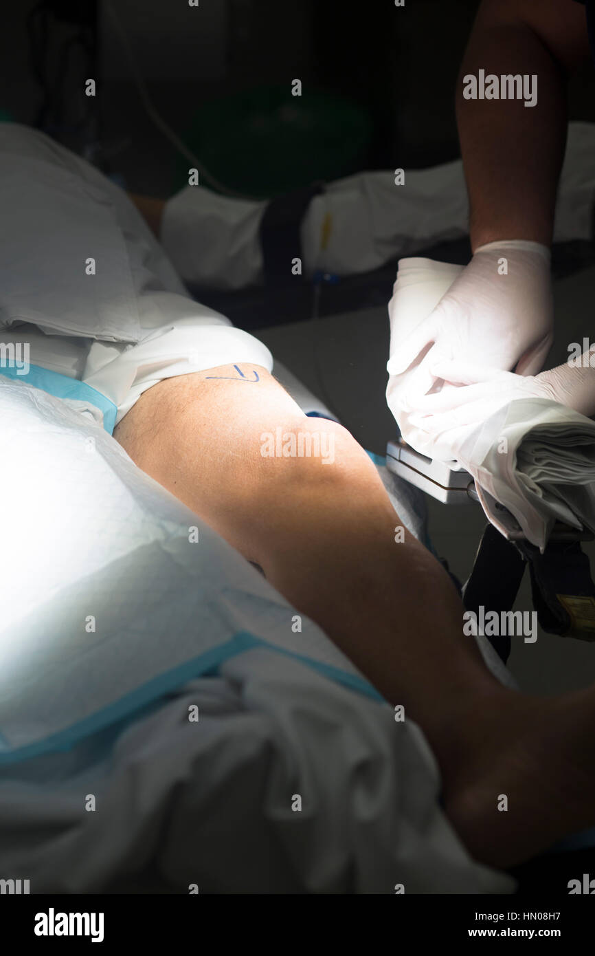 Patient leg in operating theater with surgical bandage in hospital ...