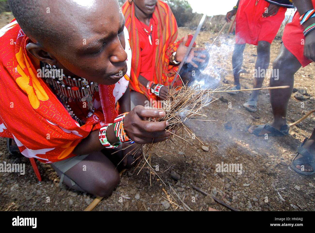 Many masais develop affections on their eyes. Tribeman making fire ...
