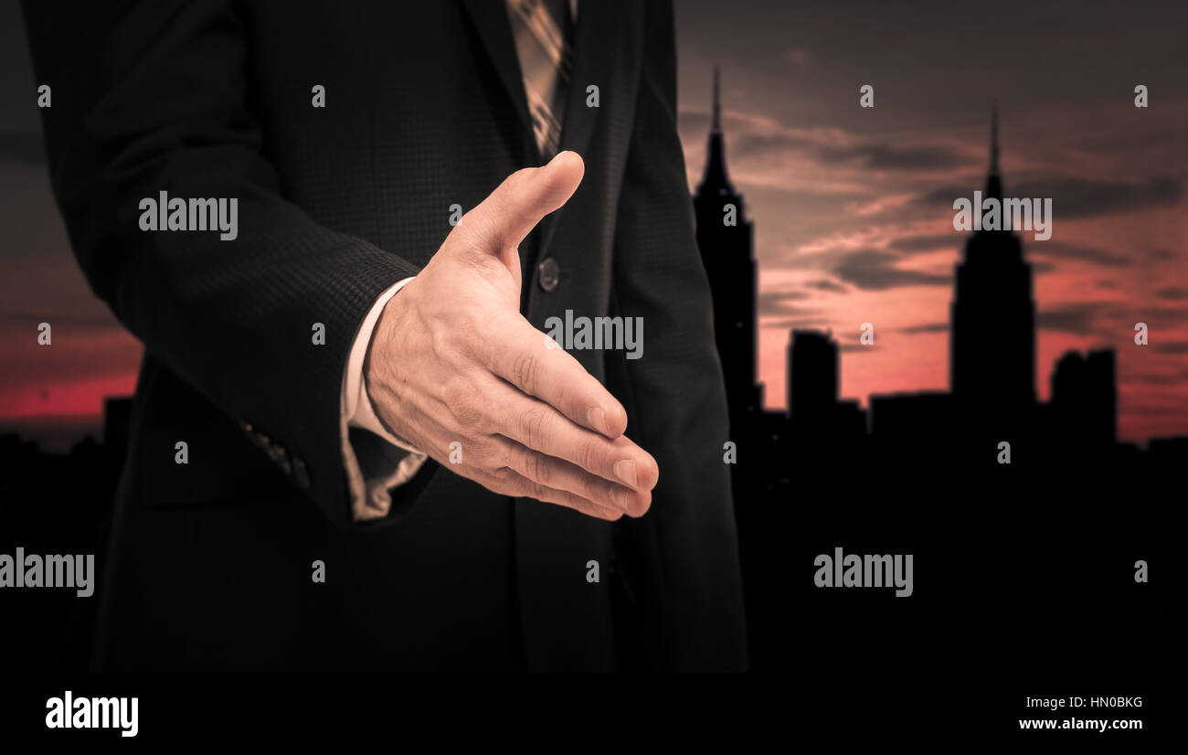 Businessman giving his hand for handshake to partner Stock Photo - Alamy