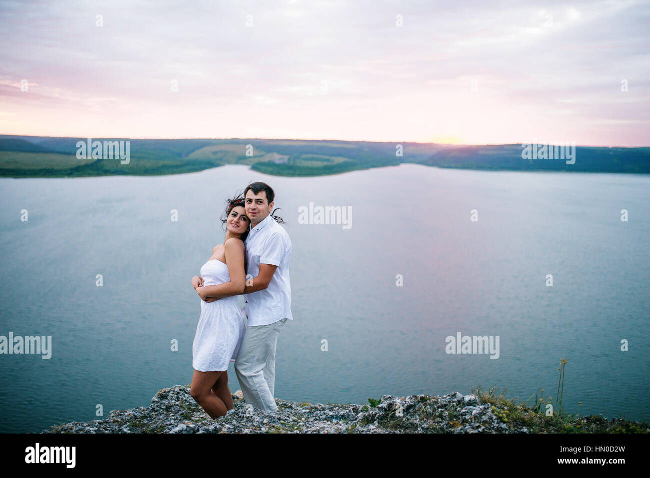 Loved couple in love at amazing landscape against cliff rocks Stock ...