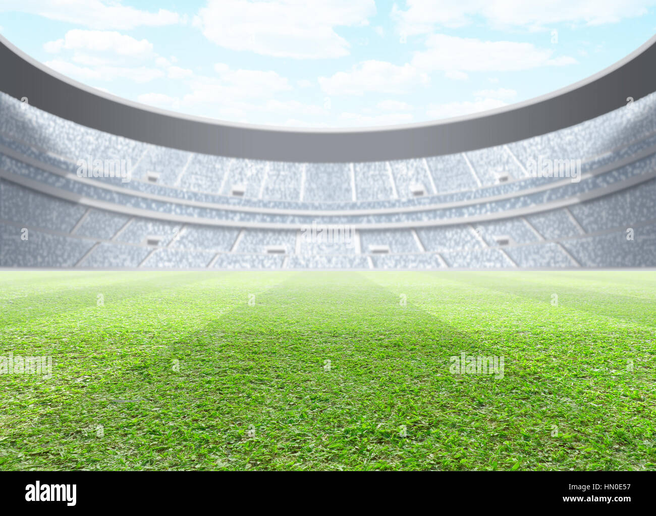 A generic seated stadium with a green grass pitch in the day time under ...