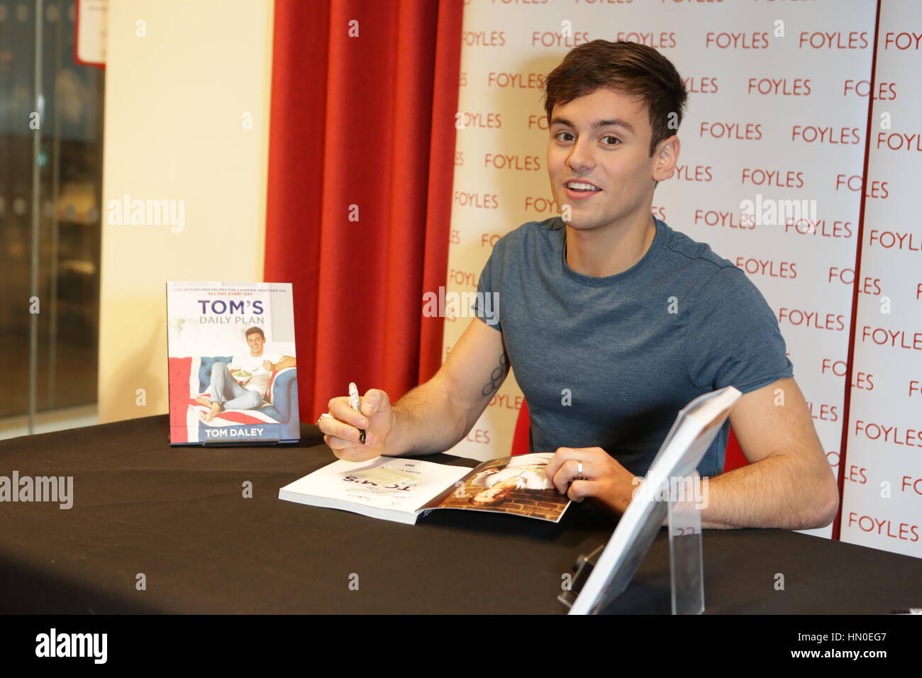 Gold medal-winning British diver Tom Daley, signs copies of his new ...