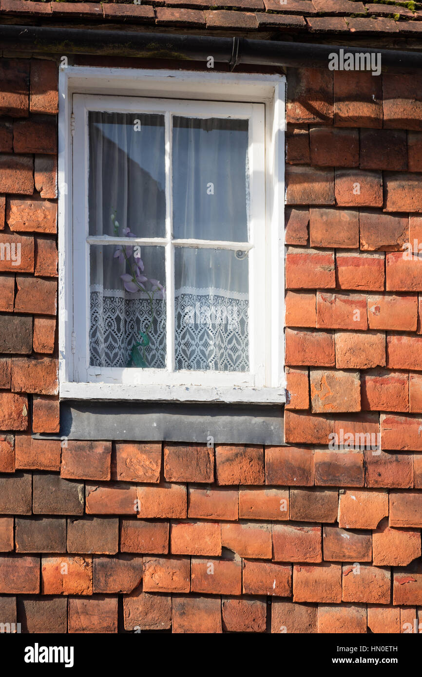 Window in a traditional peg tile hung facade on a historic cottage in ...