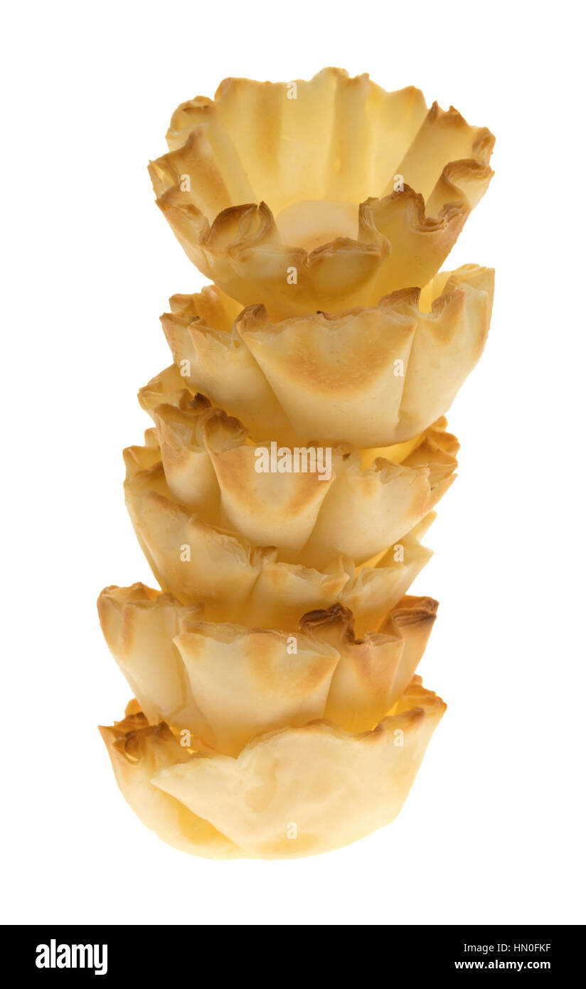 Several miniature phyllo shells with one atop the other in a stack ...