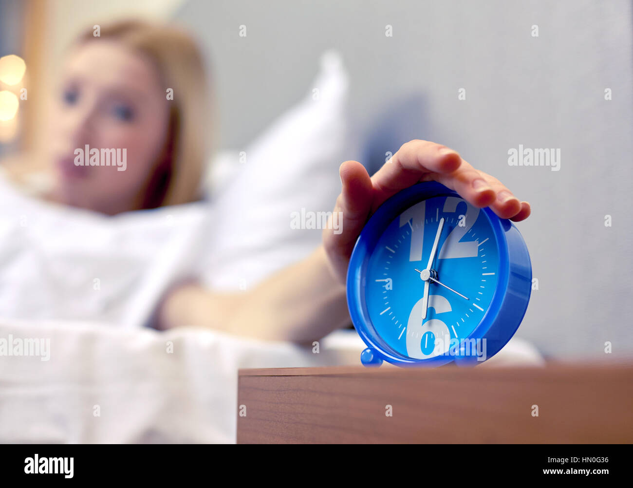 Hand on alarm clock hi-res stock photography and images - Alamy
