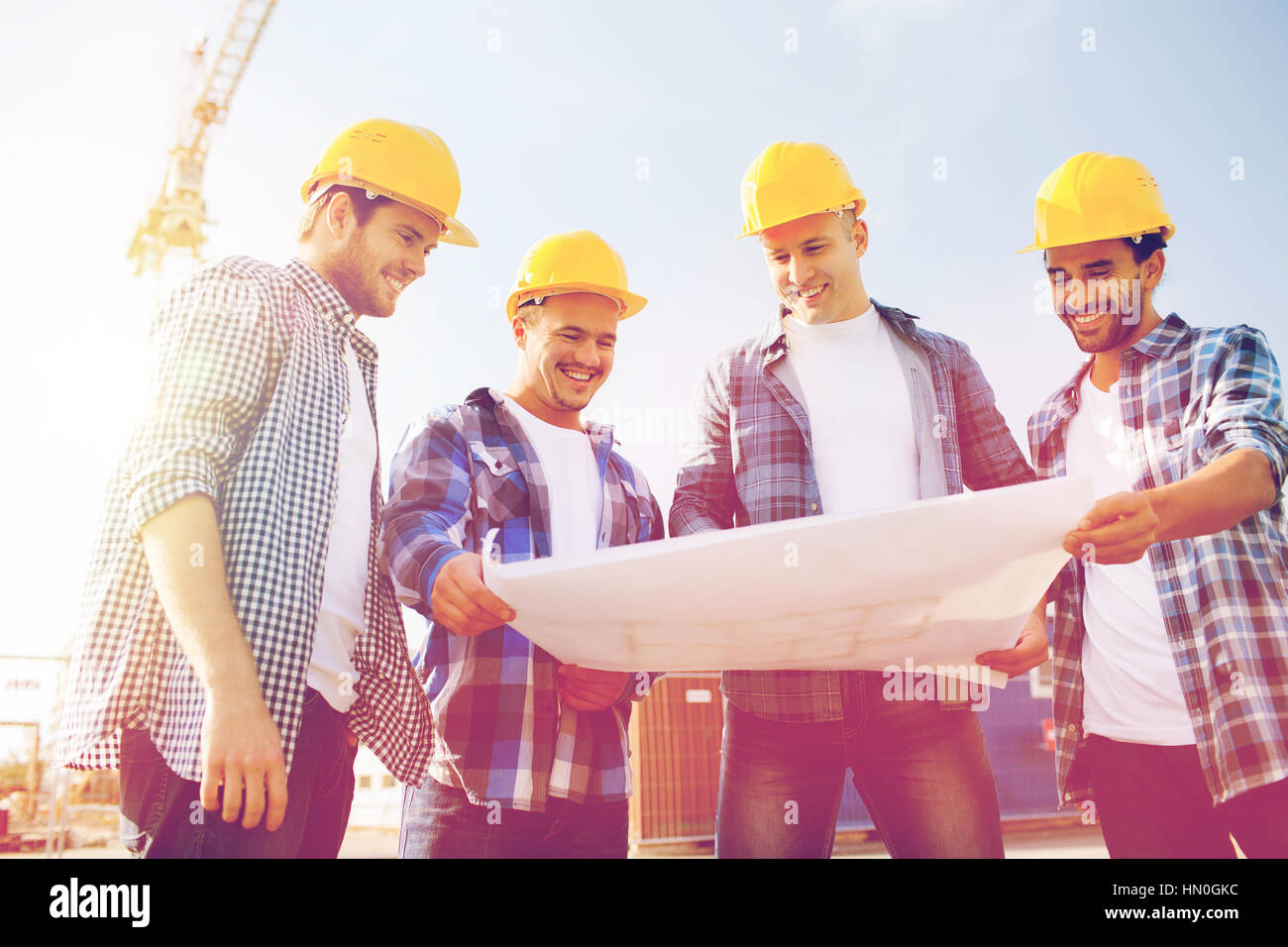 group of builders with tablet pc and blueprint Stock Photo - Alamy